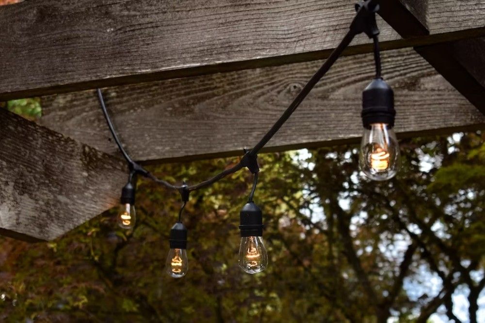 How to Hang Outdoor String Lights to Illuminate Your Backyard Oasis